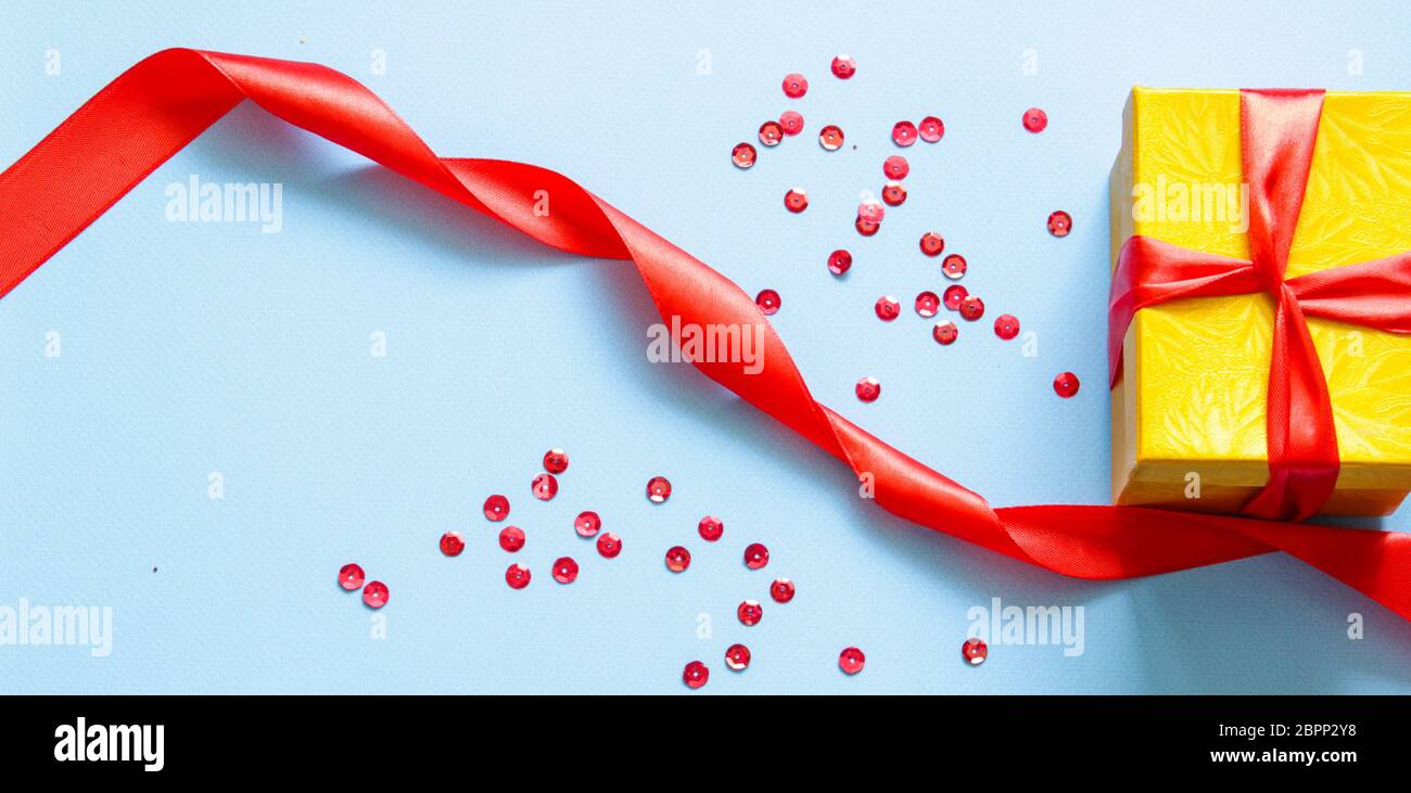 Surprise box with untied red ribbon on a blue backgroundon. Flat lay ...