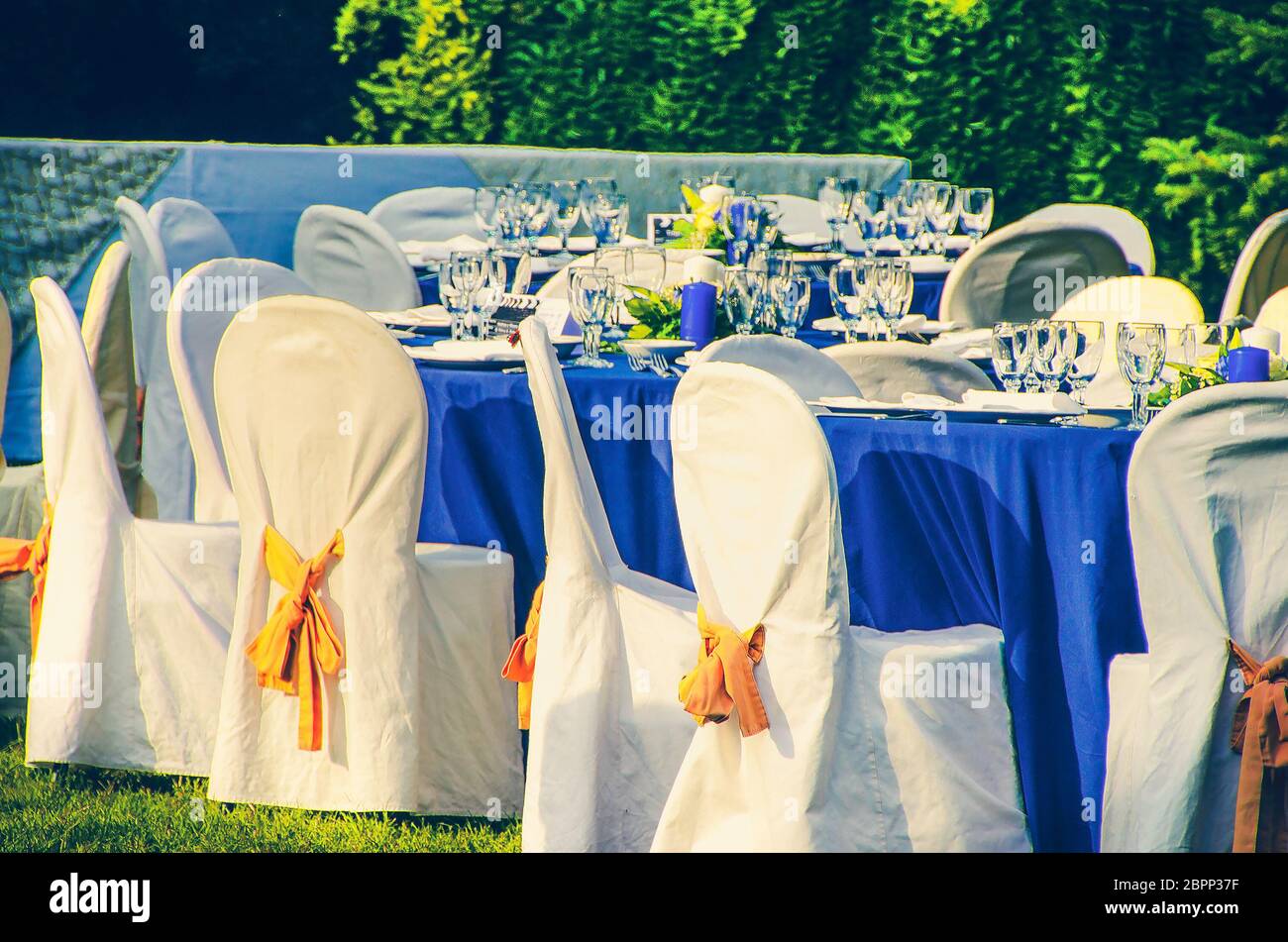 wedding chairs catering table background in garden Stock Photo - Alamy