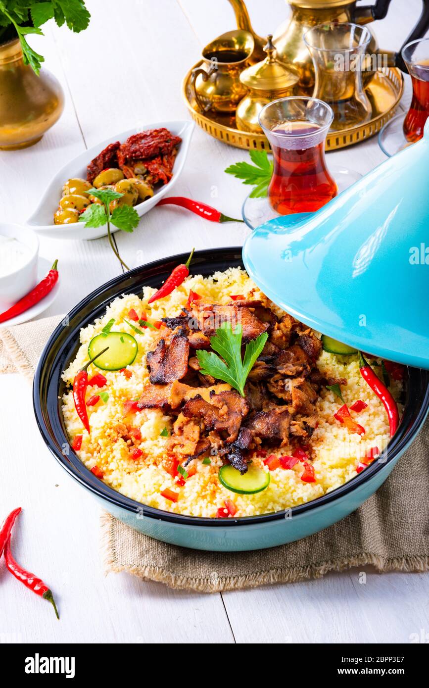 Tajin with couscous, vegetables and meat on white background Stock ...
