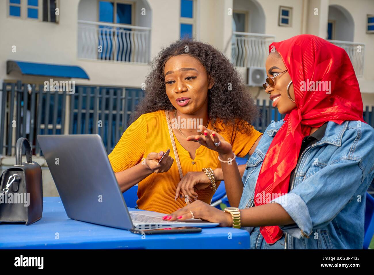 two young african girls shopping online together Stock Photo - Alamy