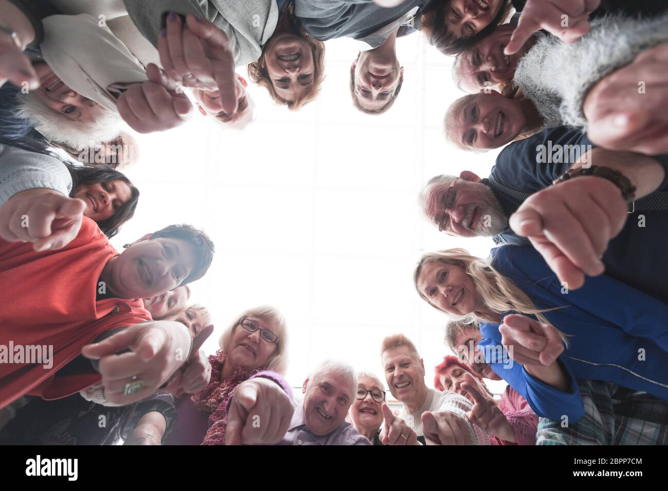 Group of smiling people pointing at the camera Stock Photo - Alamy