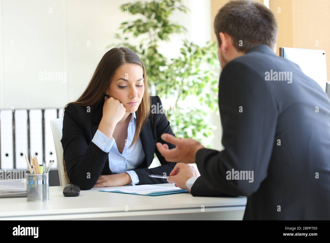 Bad salesman trying to convince to a bored client in her office or ...