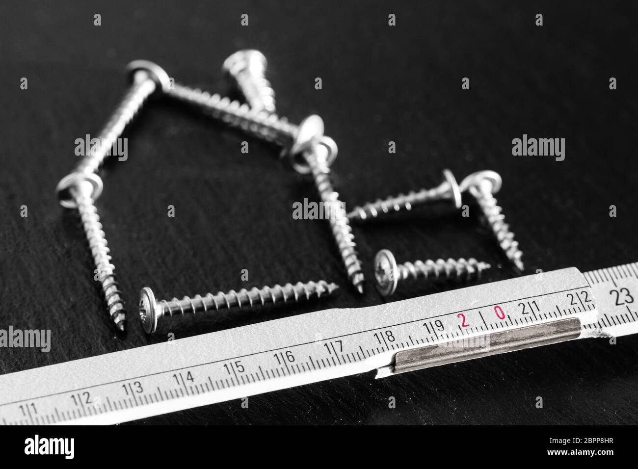 Screws and folding meter stick visualize constructional housebuilding ...