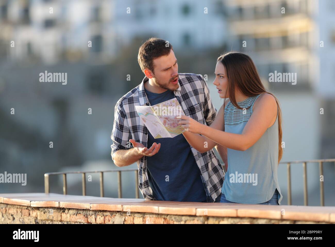Angry couple arguing about travel destination on vacation in a town ...