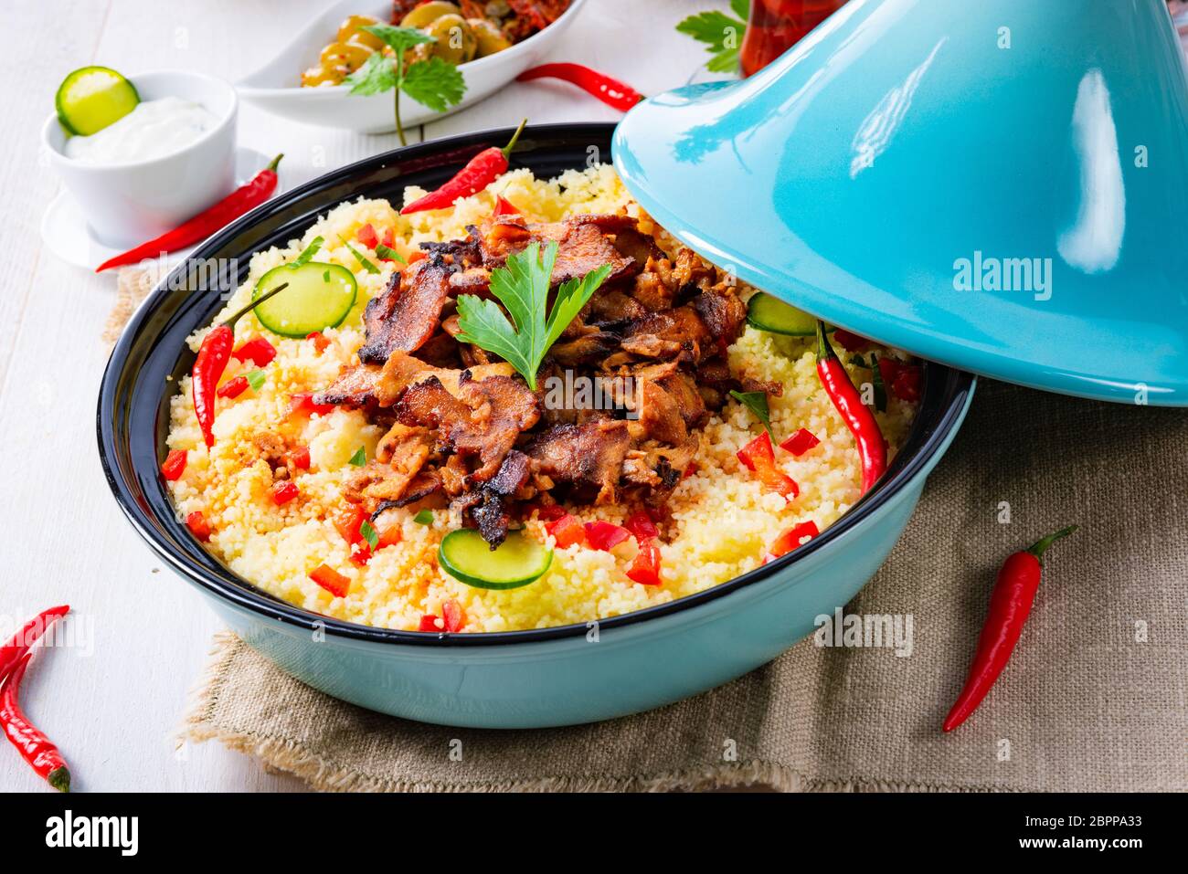 Tajin with couscous, vegetables and meat on white background Stock ...