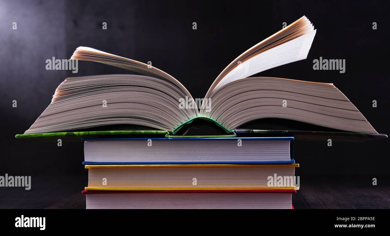 Composition with open book on the table Stock Photo - Alamy