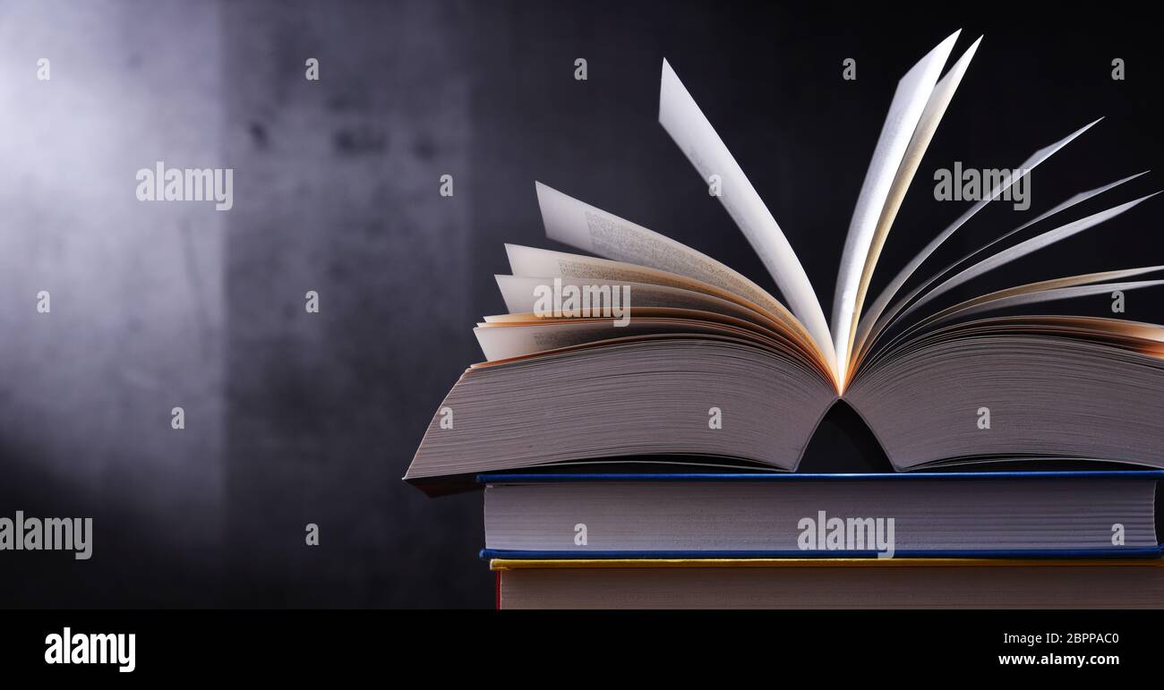 Composition with open book on the table Stock Photo - Alamy