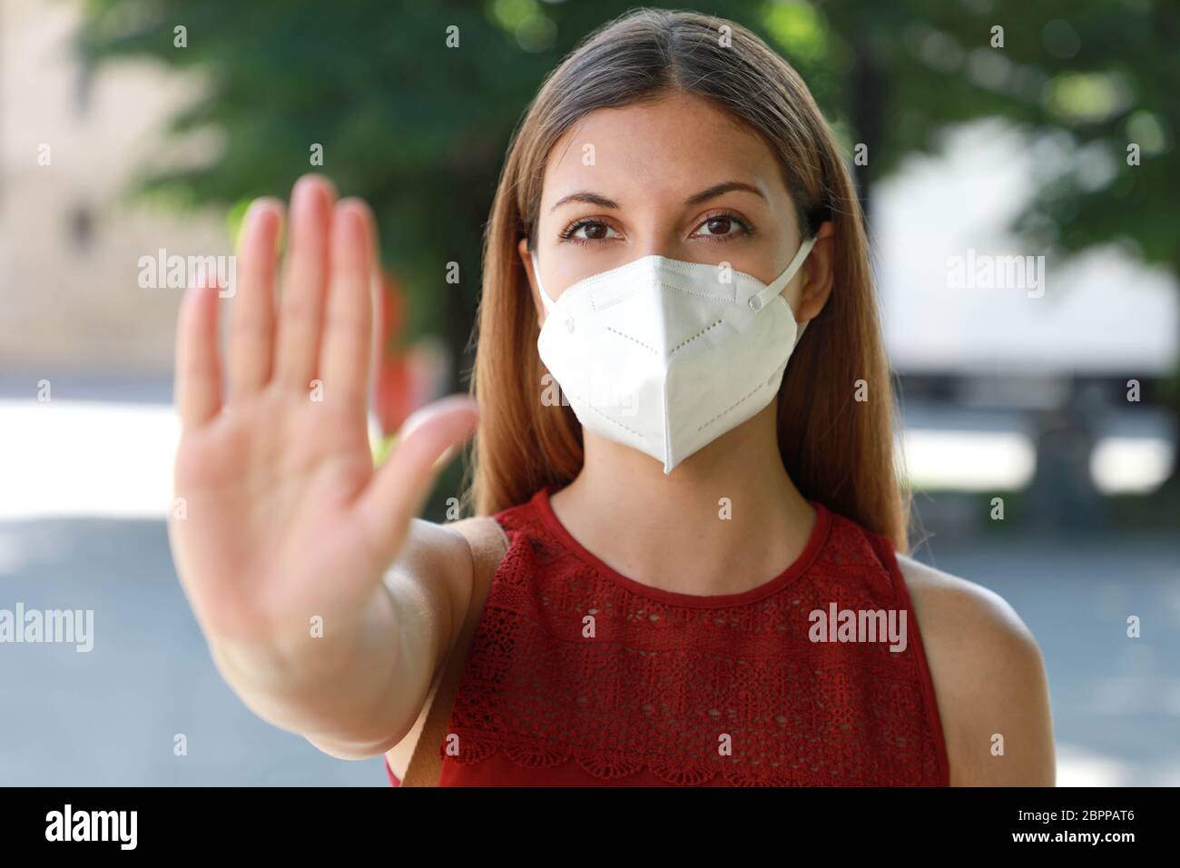 STOP COVID-19 Young Woman Wearing KN95 FFP2 Mask on her Face Showing ...