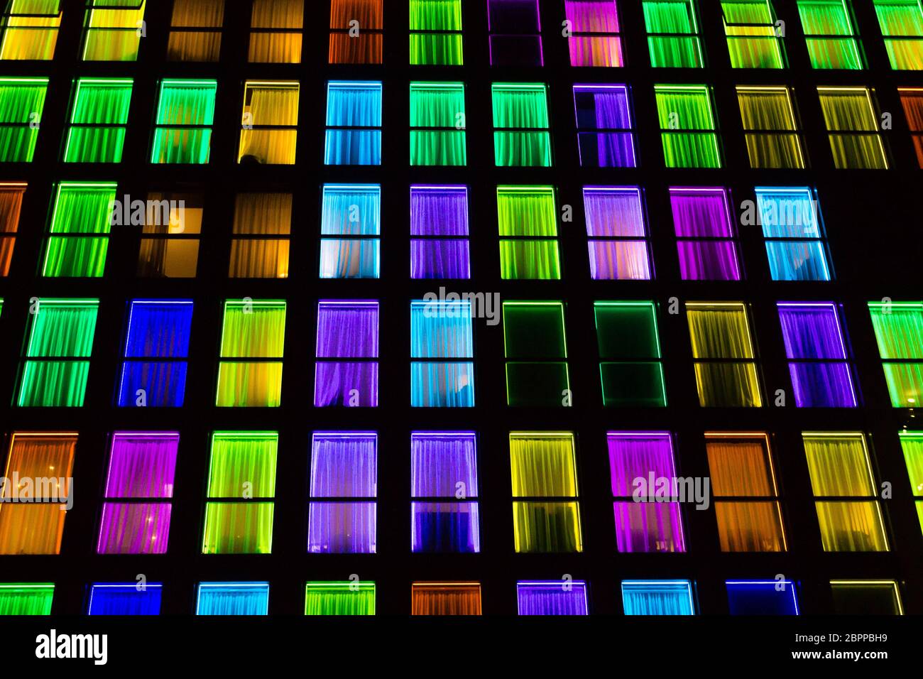 Colored windows texture. Windows illuminated by neon lights background ...