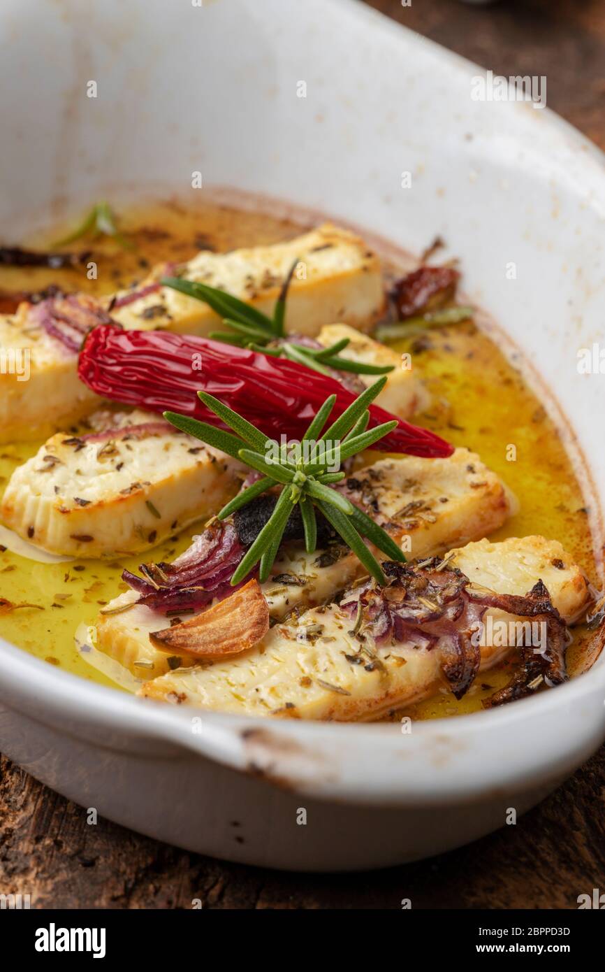 grilled feta with herbs in oil Stock Photo - Alamy