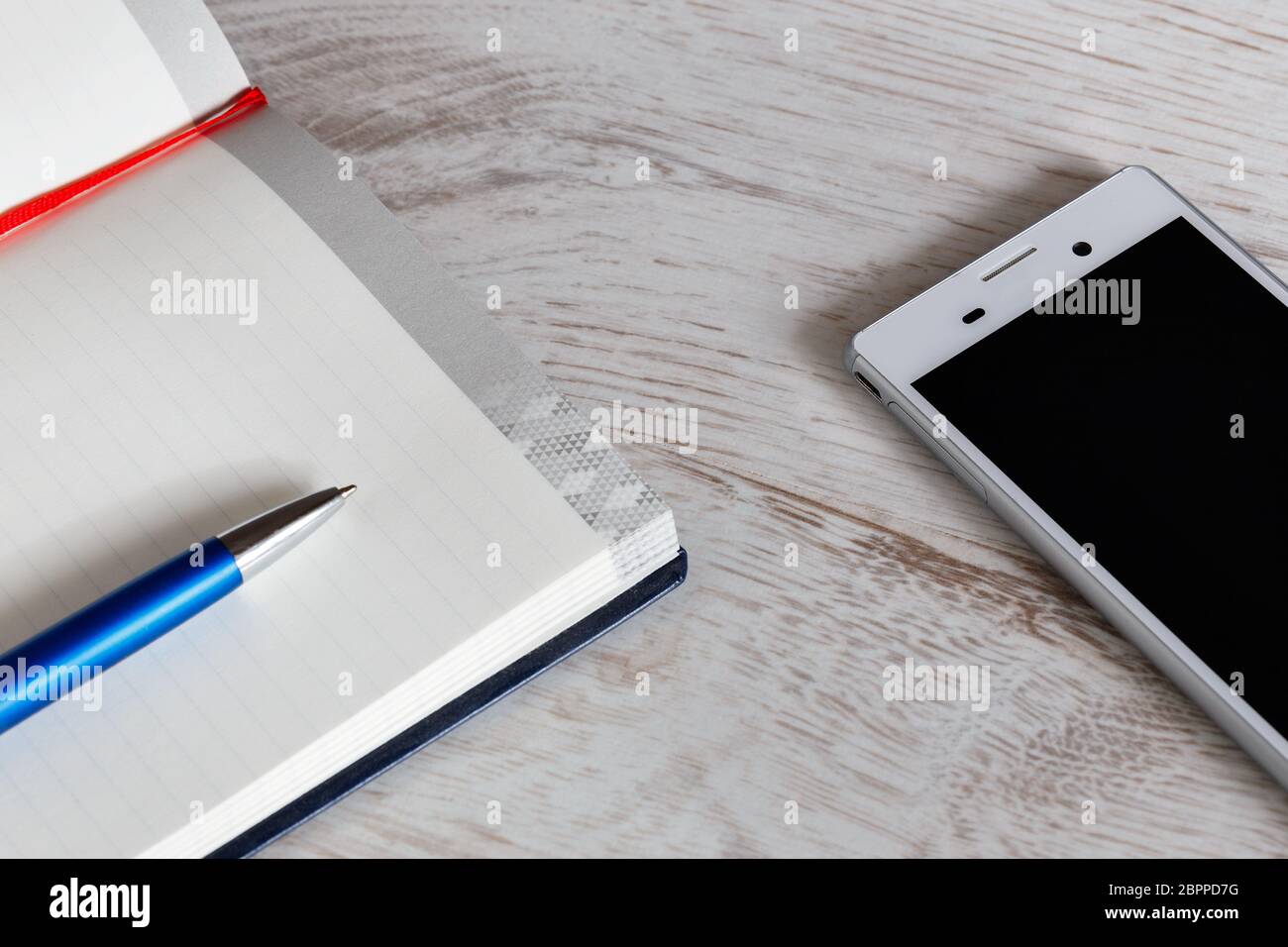 notepad and telephone on the desk, work environment Stock Photo - Alamy