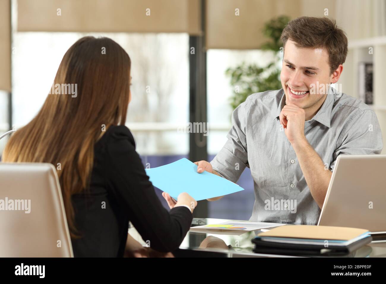 Businesspeople meeting and working and sharing documents in a desk at ...