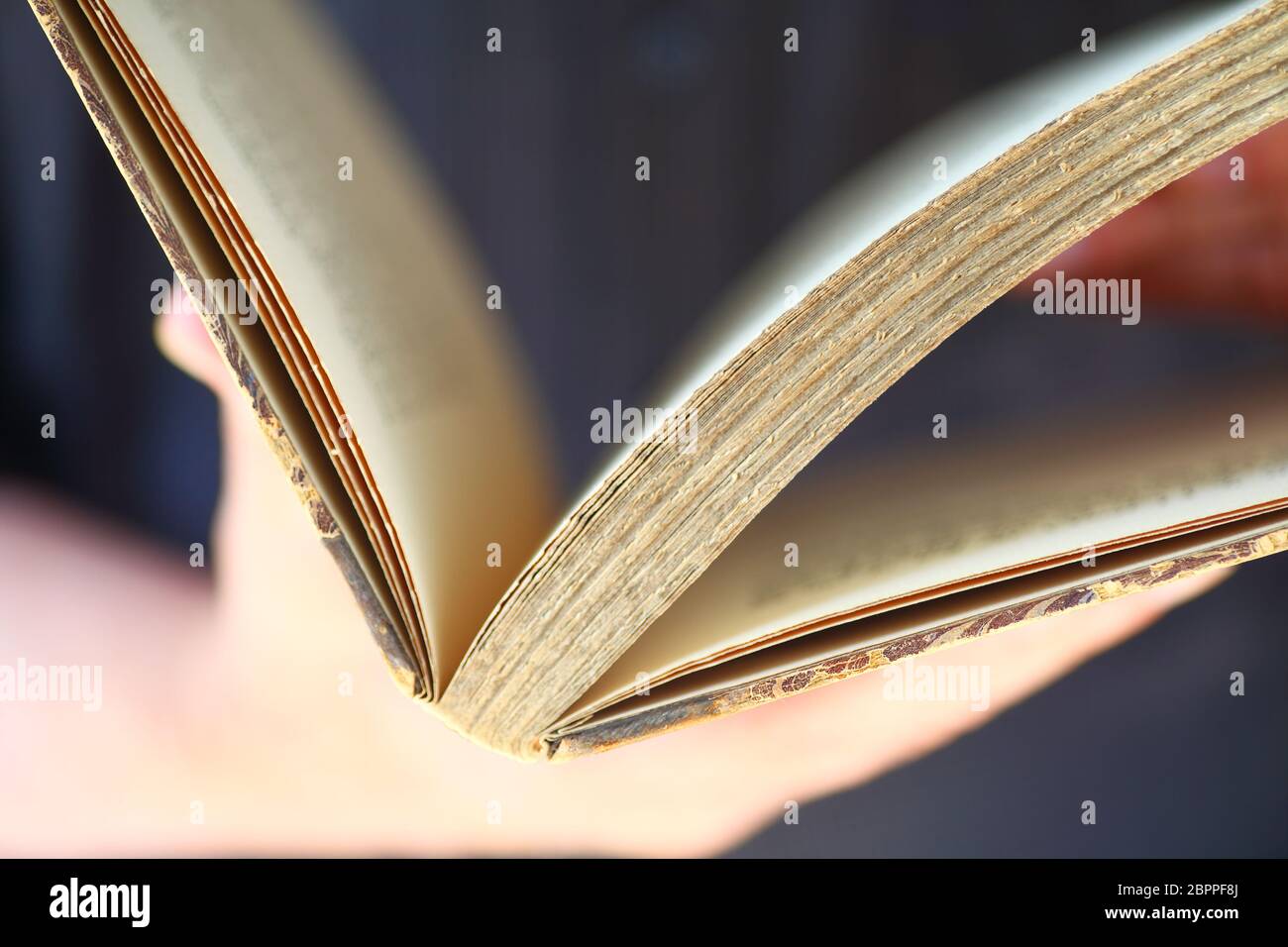 A vintage book held by man closeup Stock Photo - Alamy