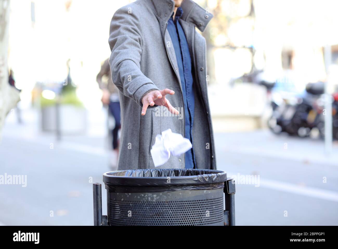 Boy throwing garbage into trash can hi-res stock photography and images ...
