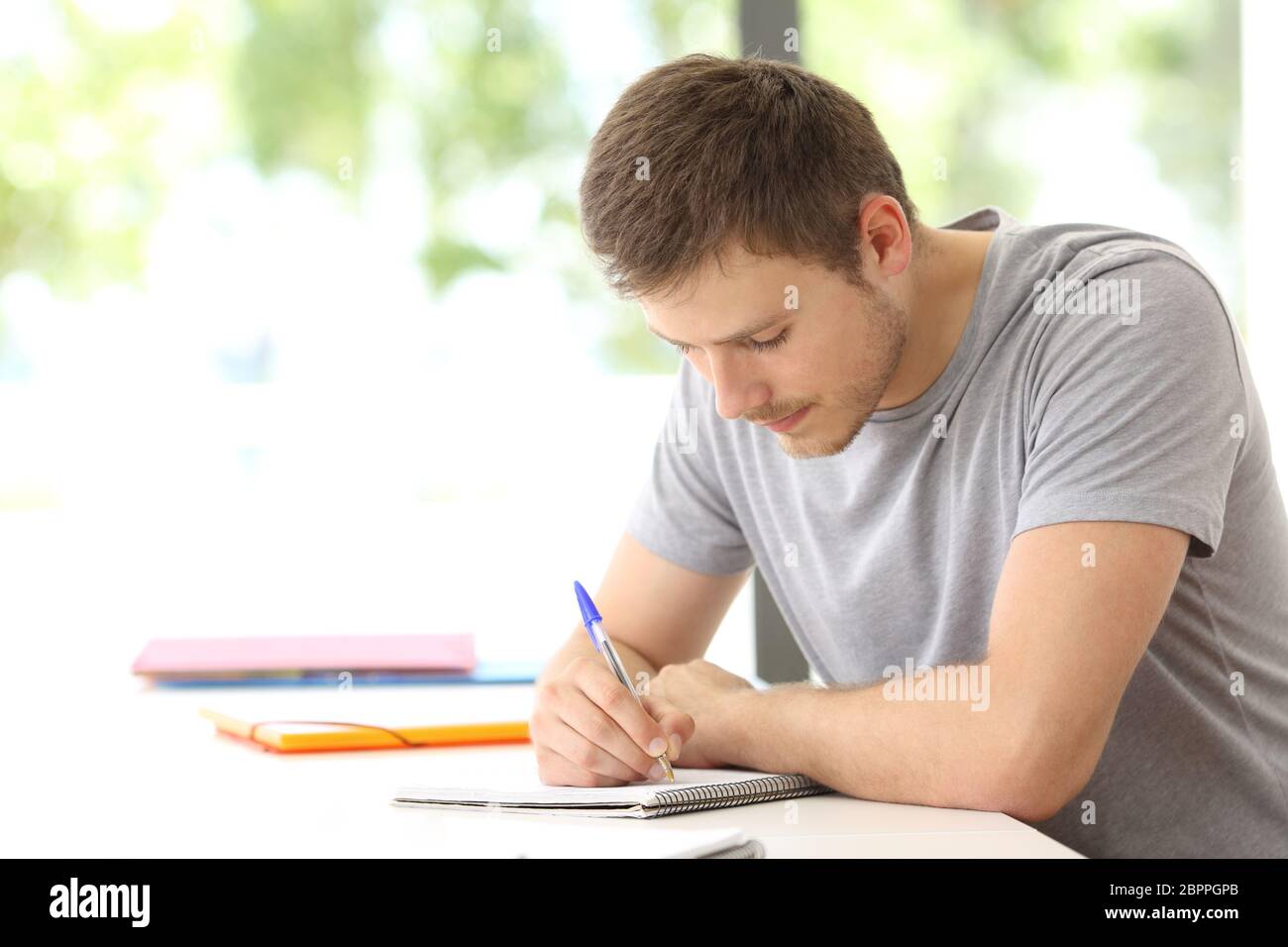 Single student studying taking notes alone in a classroom Stock Photo ...
