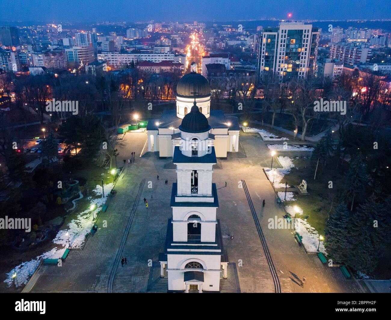Aerial drone view of chisinau city center at night with lights and blue ...