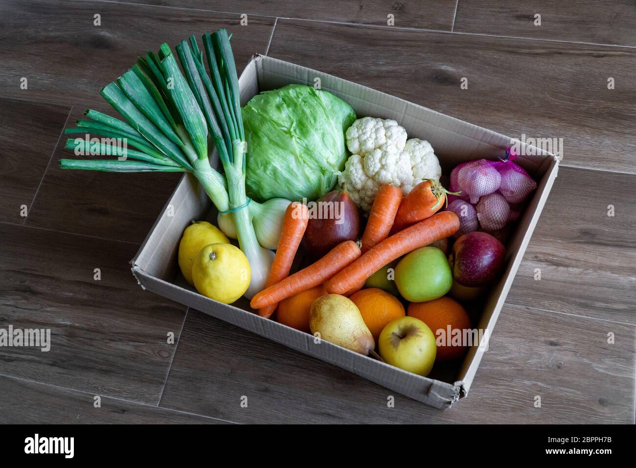 Fresh vegetables in cardboard box on brown wood background Stock Photo ...