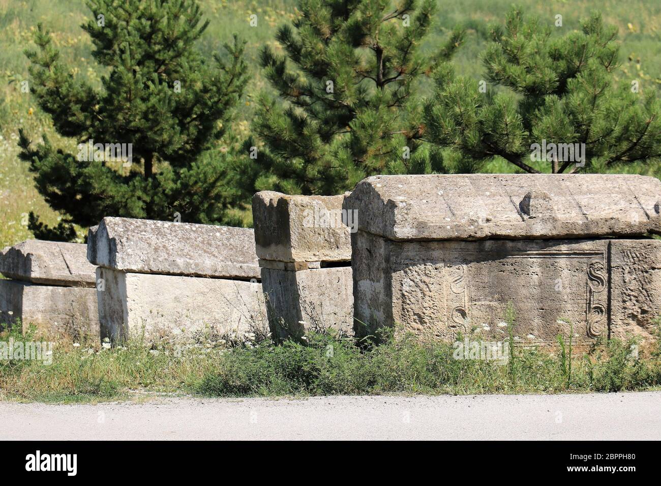Old closed stone tombs outside in green field Stock Photo - Alamy