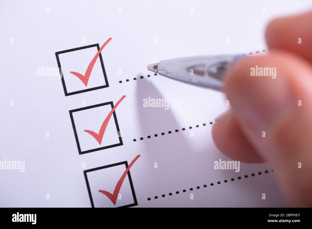 Close-up Of Person's Hand Marking On Checklist With Pen Stock Photo - Alamy