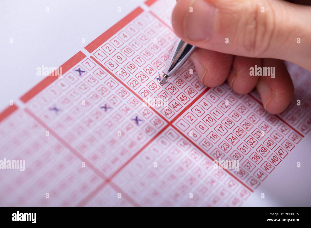 Close-up Of A Person Marking Number On Lottery Ticket With Pen Stock ...