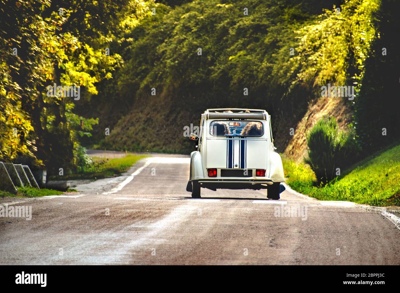 vintage car country winding road back view friends road trip Stock ...