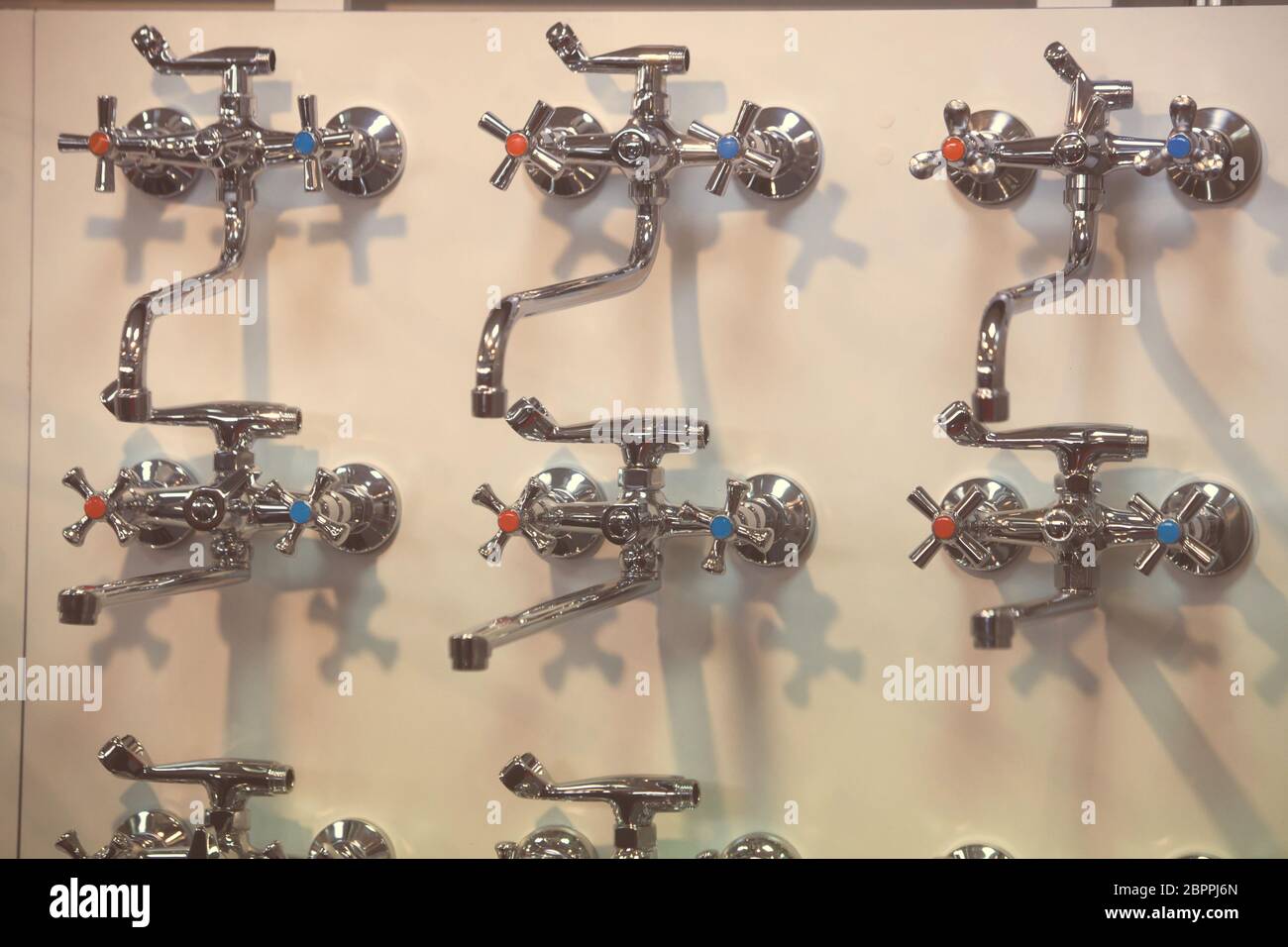 Color image of many faucets on a wall Stock Photo - Alamy