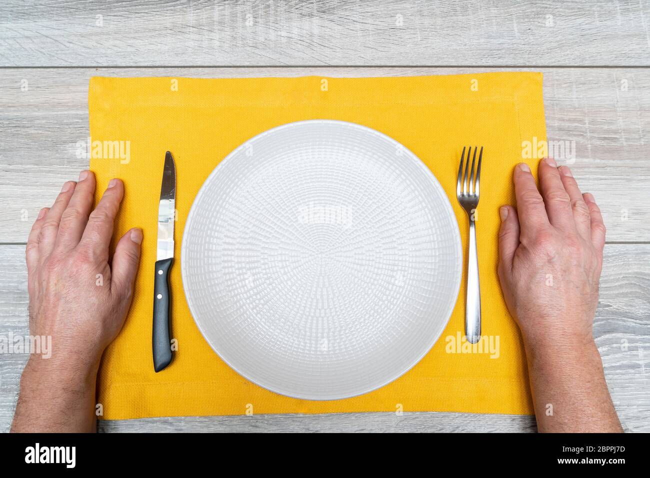 Hungry man empty plate hi-res stock photography and images - Alamy
