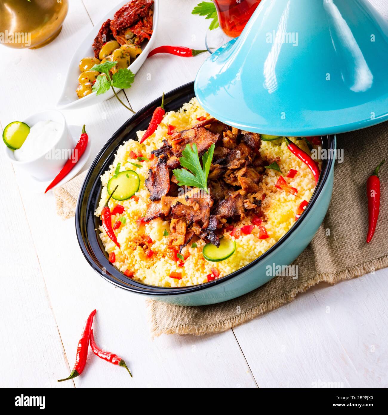 Tajin with couscous, vegetables and meat on white background Stock ...