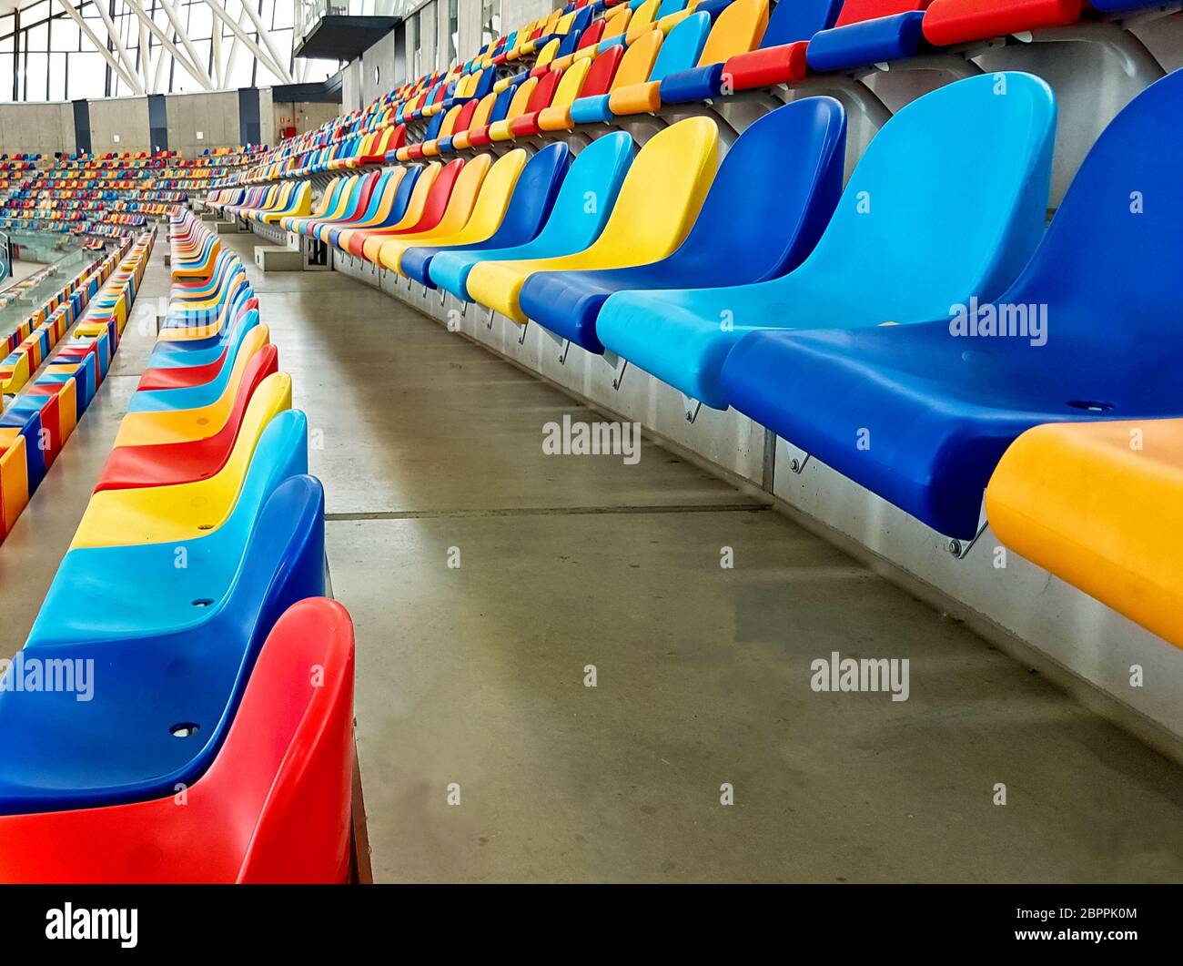 Benches of different colors in a sports stadium Stock Photo - Alamy