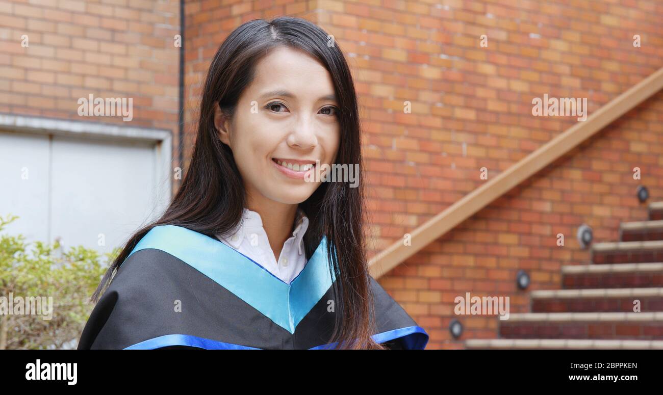 Beautiful woman with graduation gown Stock Photo - Alamy