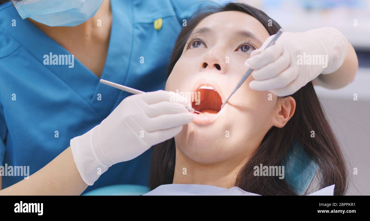 Doctor dentist working with patient in dental clinic Stock Photo - Alamy