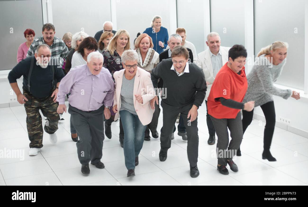 Successful business team running in the office hall Stock Photo - Alamy