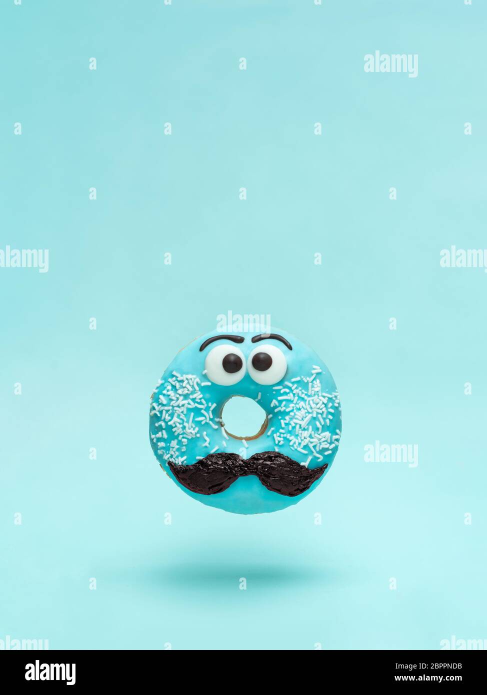 Blue glazed donut with mustache. Flying blue doughnut with funny face ...