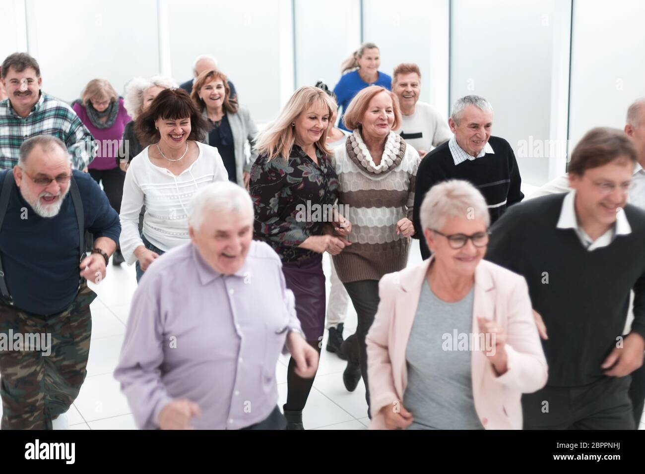 Successful business team running in the office hall Stock Photo - Alamy