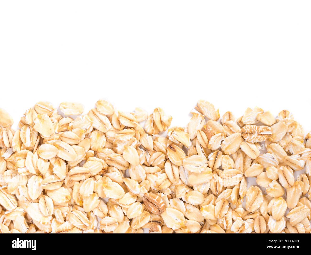 raw oatmeal on white background with copy space. Isolated one edge. Top ...