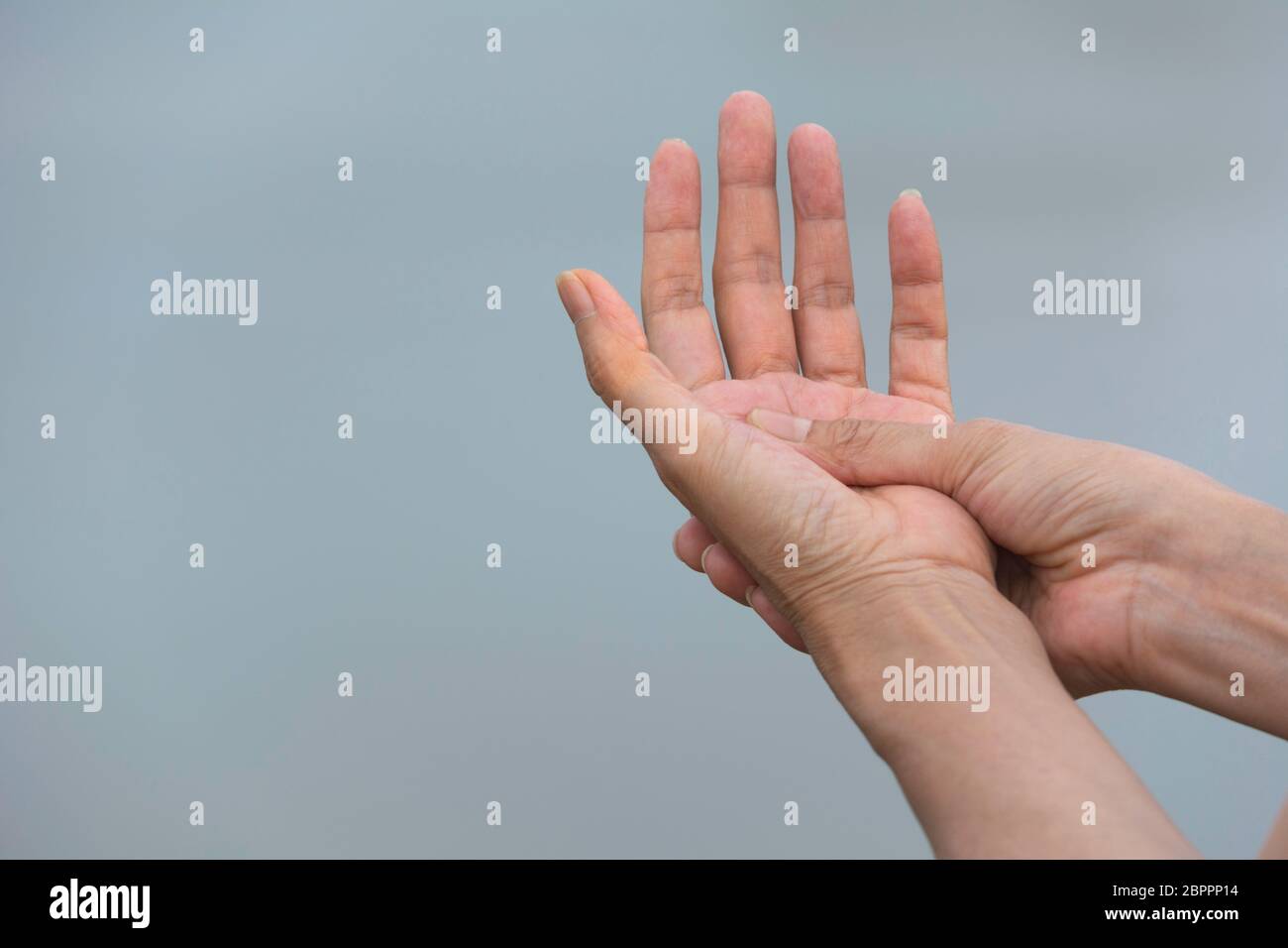 Woman holding her hand. Pain in a woman hand. Female massaging painful ...