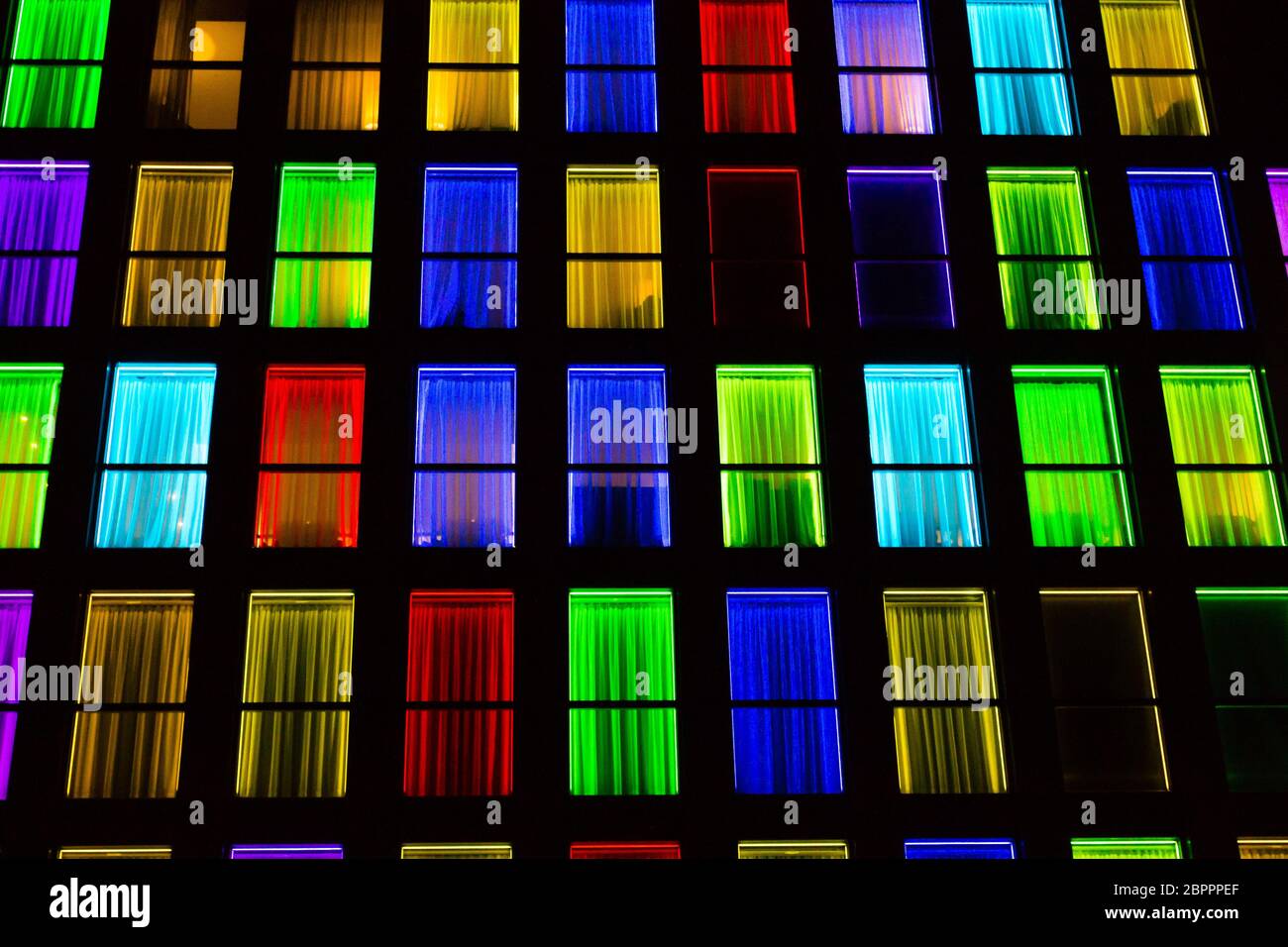 Colored windows texture. Windows illuminated by neon lights background ...