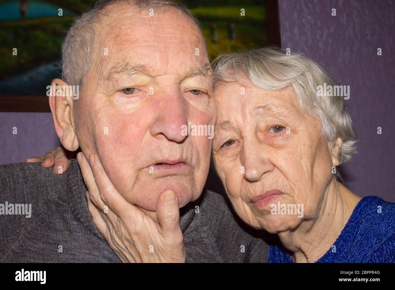 Portrait of a sad sick elder couple at home. The senior people and ...
