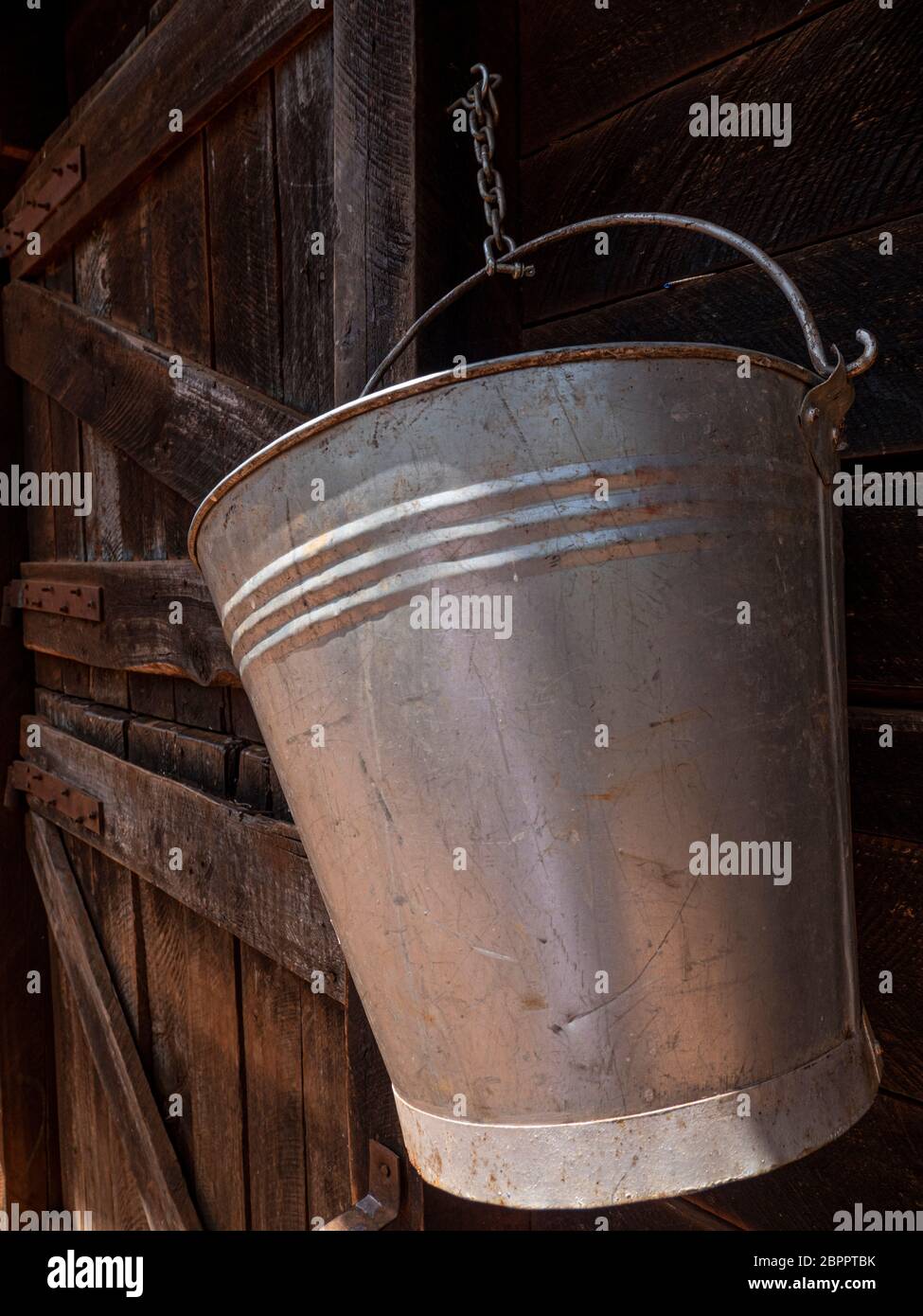 Tin bucket hung up in a barn for feeding animals Stock Photo - Alamy