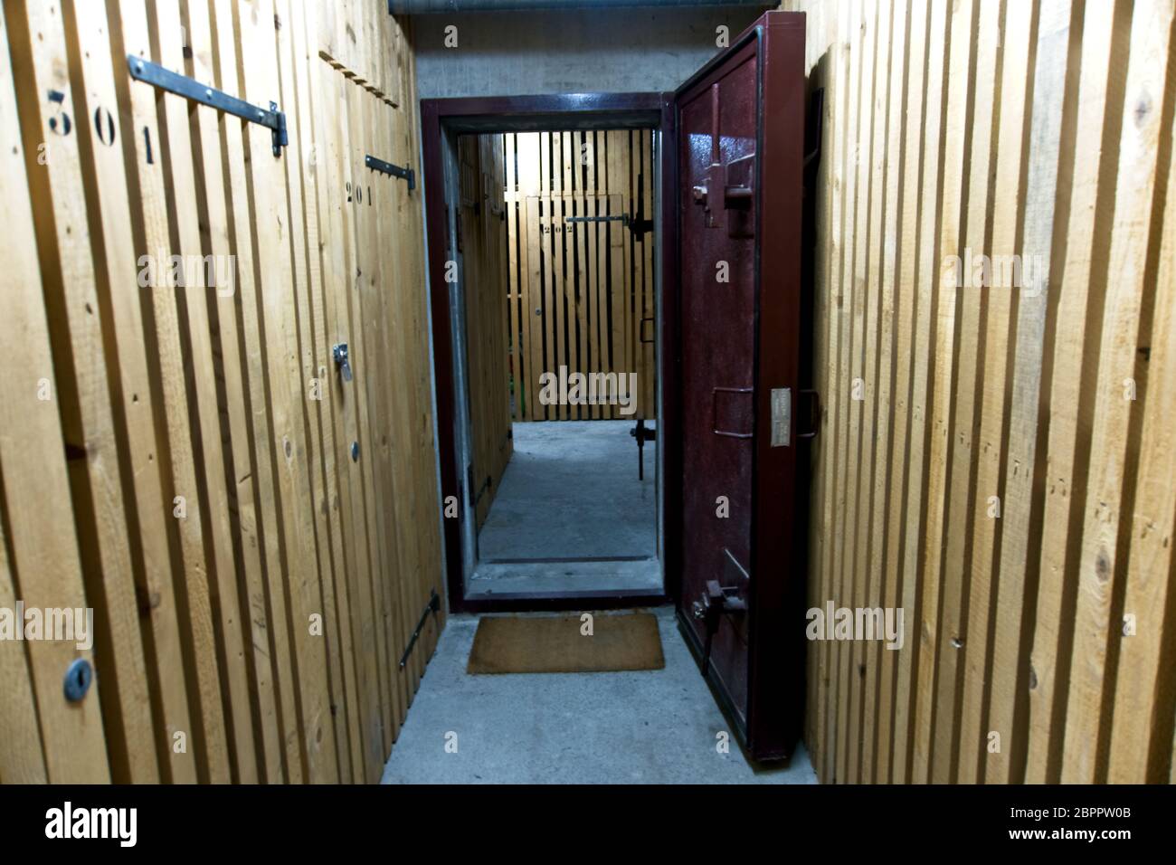 Inside of a bunker with a wooden interior and an open metal door to ...