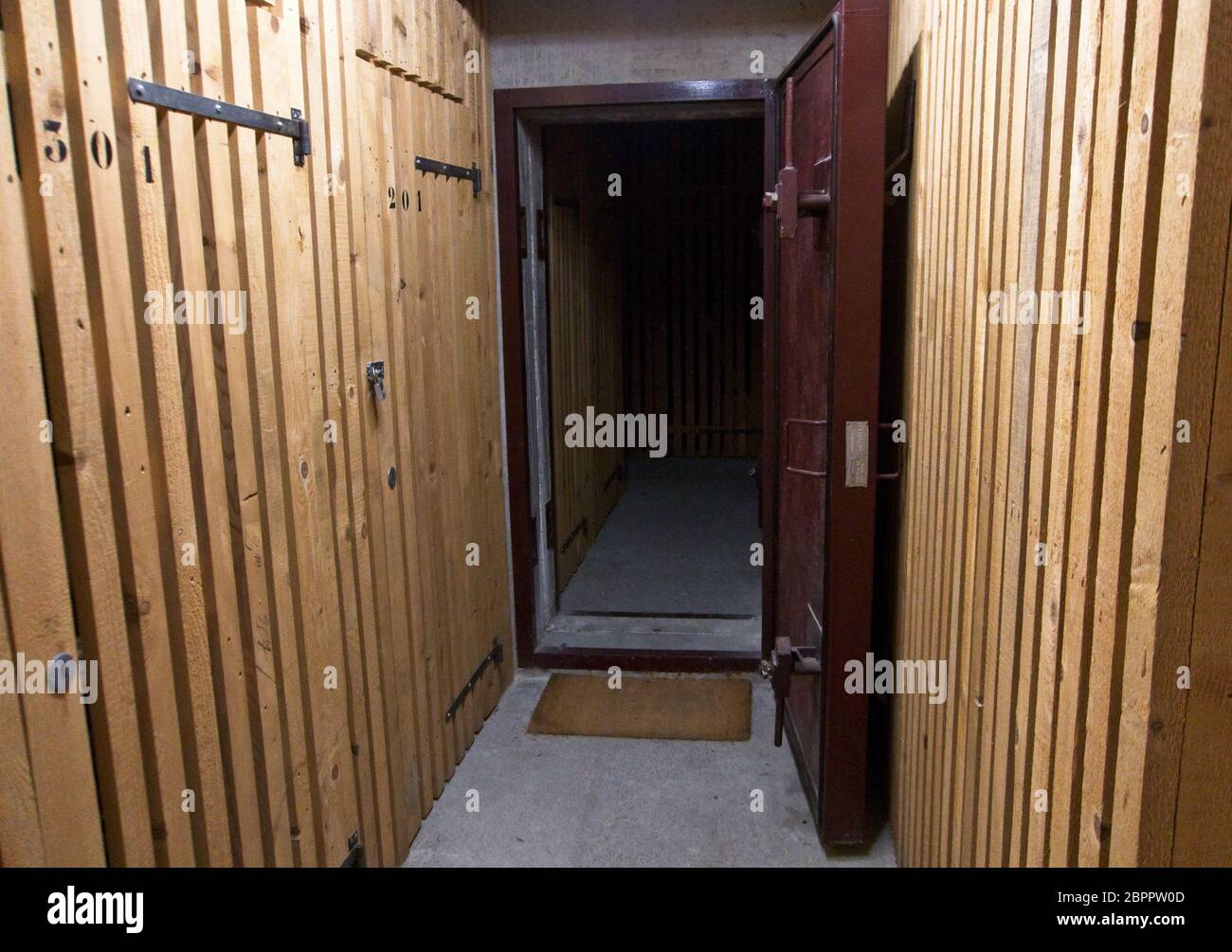 Inside of a bunker with a wooden interior and an open metal door to ...