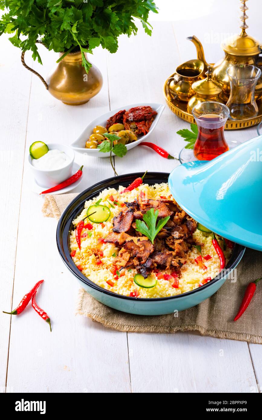 Tajin with couscous, vegetables and meat on white background Stock ...