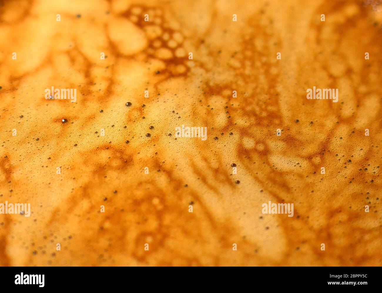 A cup of instant coffee with a little bit of milk, in close-up view ...