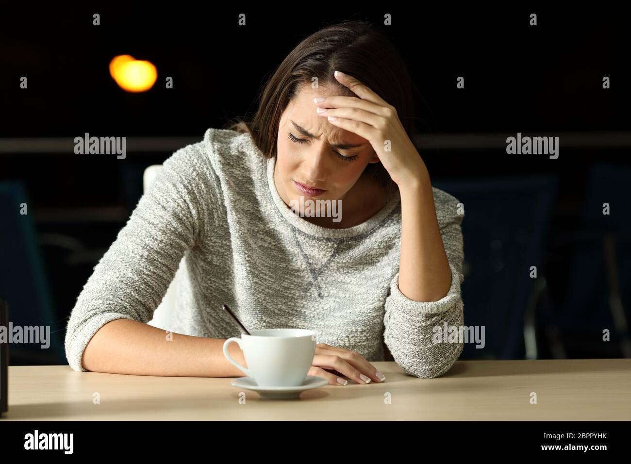 Front view portrait of a sad woman complaining in a restaurant Stock ...