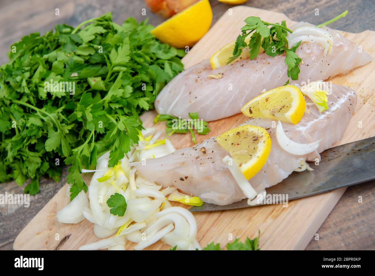Fresh fish, a raw cod fillets with addition of herbs and lemon Stock ...