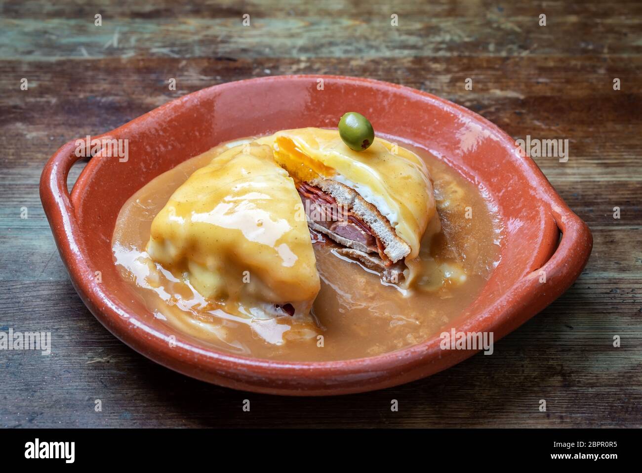 Portuguese francesine, cut in half, in a clay plate Stock Photo - Alamy