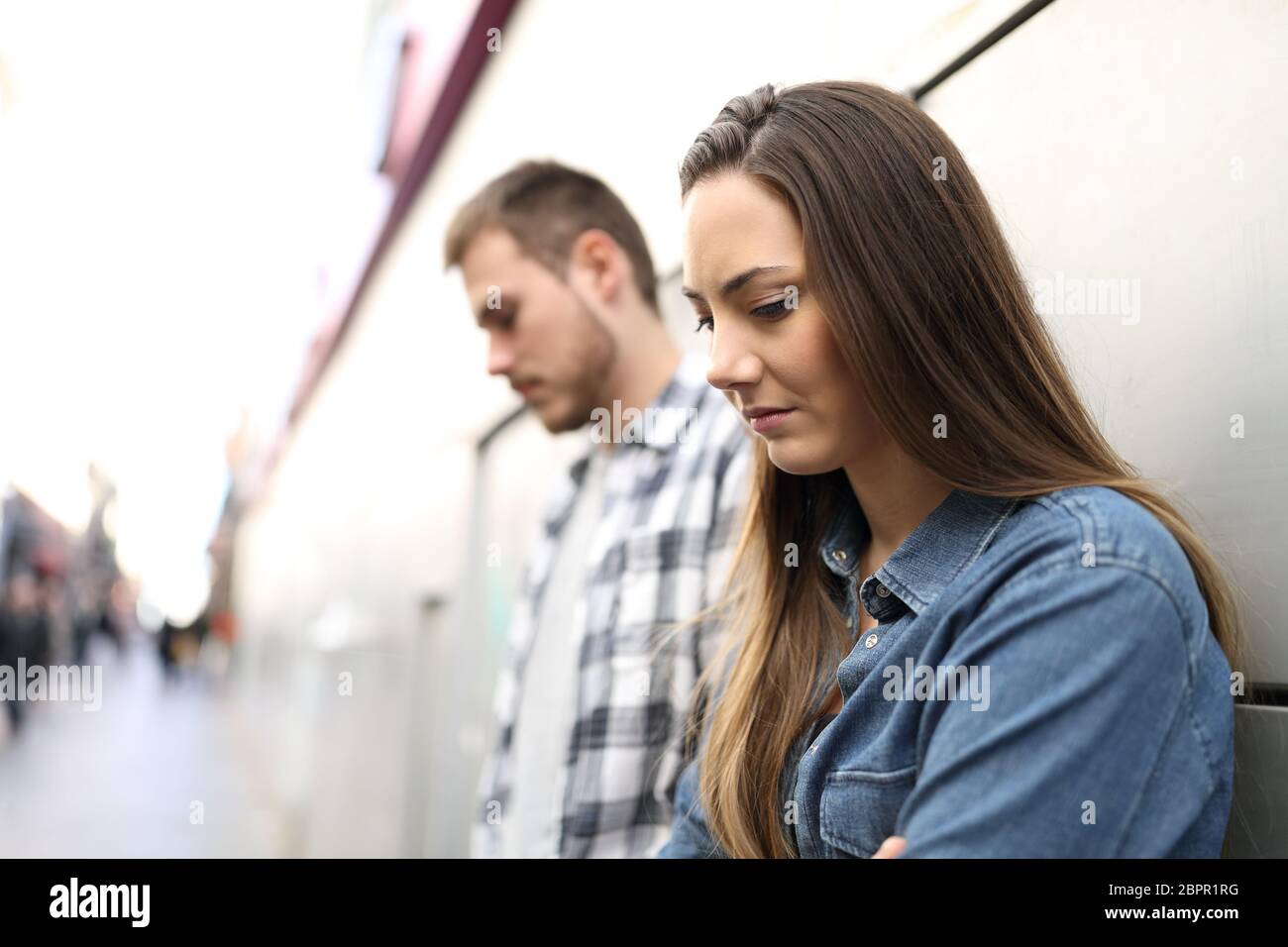 Sad couple or friends complaining ignoring each other in the street ...