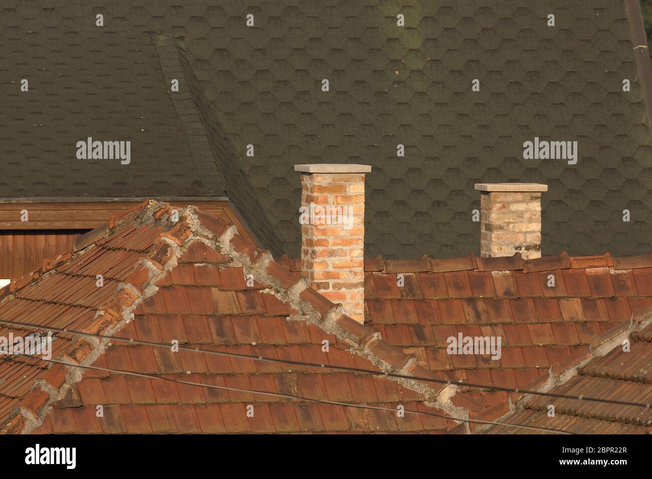 Chimneys on roofs in late afternoon light Stock Photo - Alamy