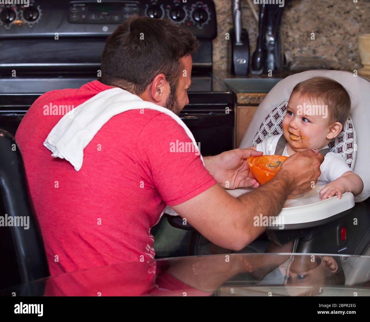 Happy young father feeding hi-res stock photography and images - Alamy