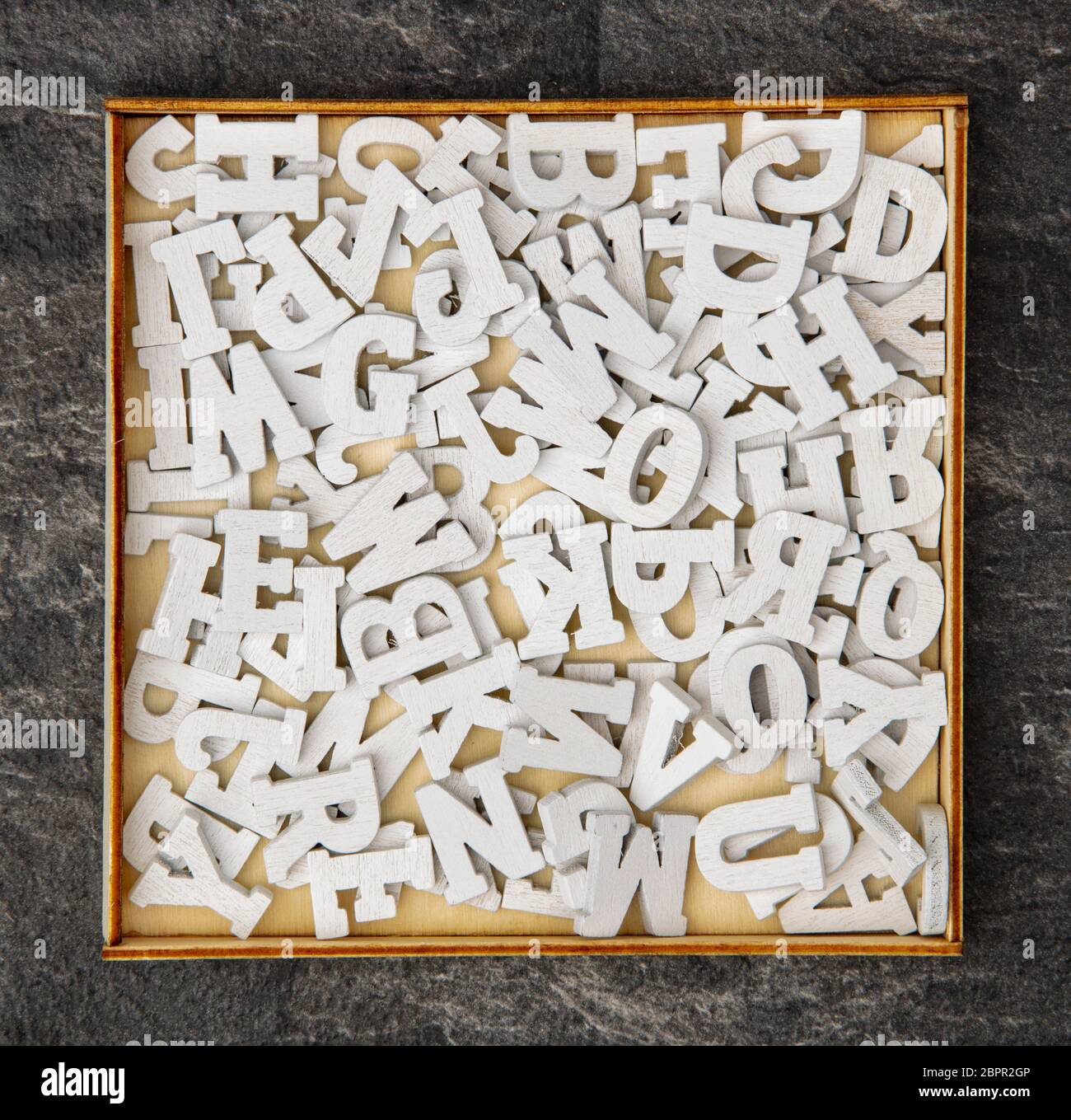Wooden toy letters in a Box on dark background Stock Photo - Alamy